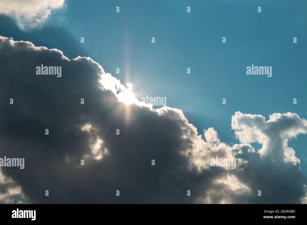 dark clouds covering the sun and blue sky. fast weather change Stock ...