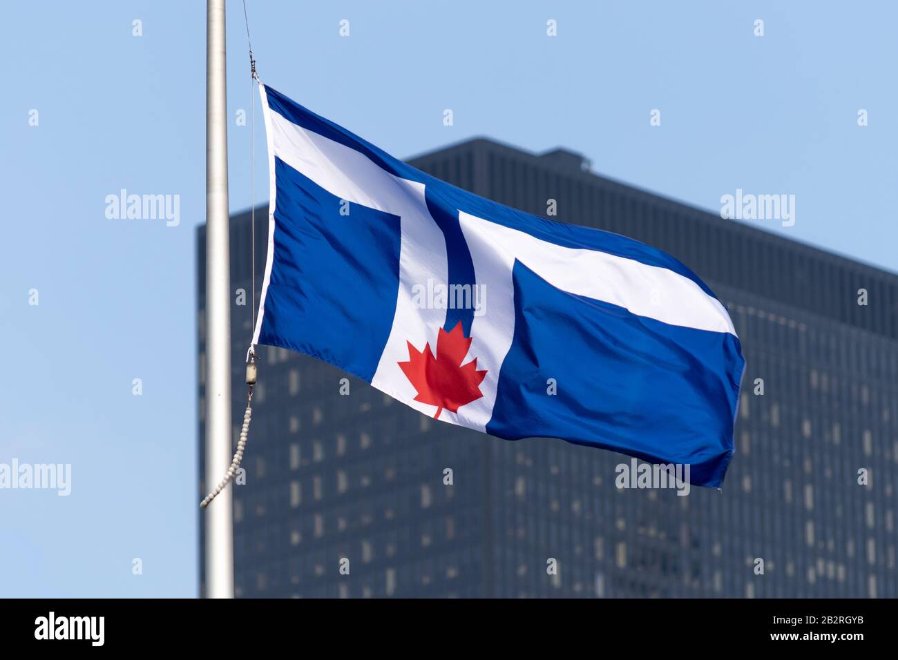 Flag of Toronto waving on a clear, sunny day in the cities downtown ...