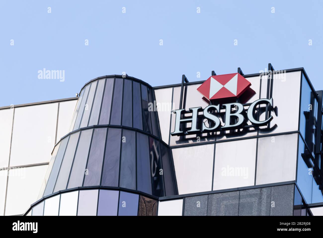 HSBC sign atop of bank branch in downtown Toronto on sunny afternoon ...