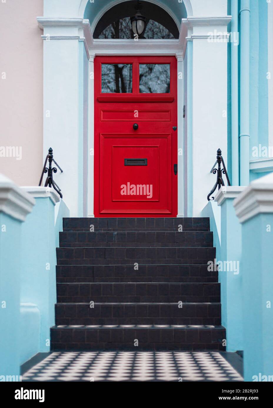 Red door with stairs and blue walls Stock Photo - Alamy