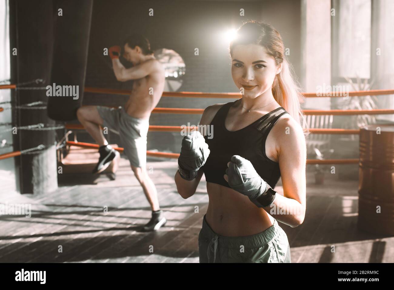 Female boxer doing shadow boxing inside a boxing ring. Boxer practicing ...