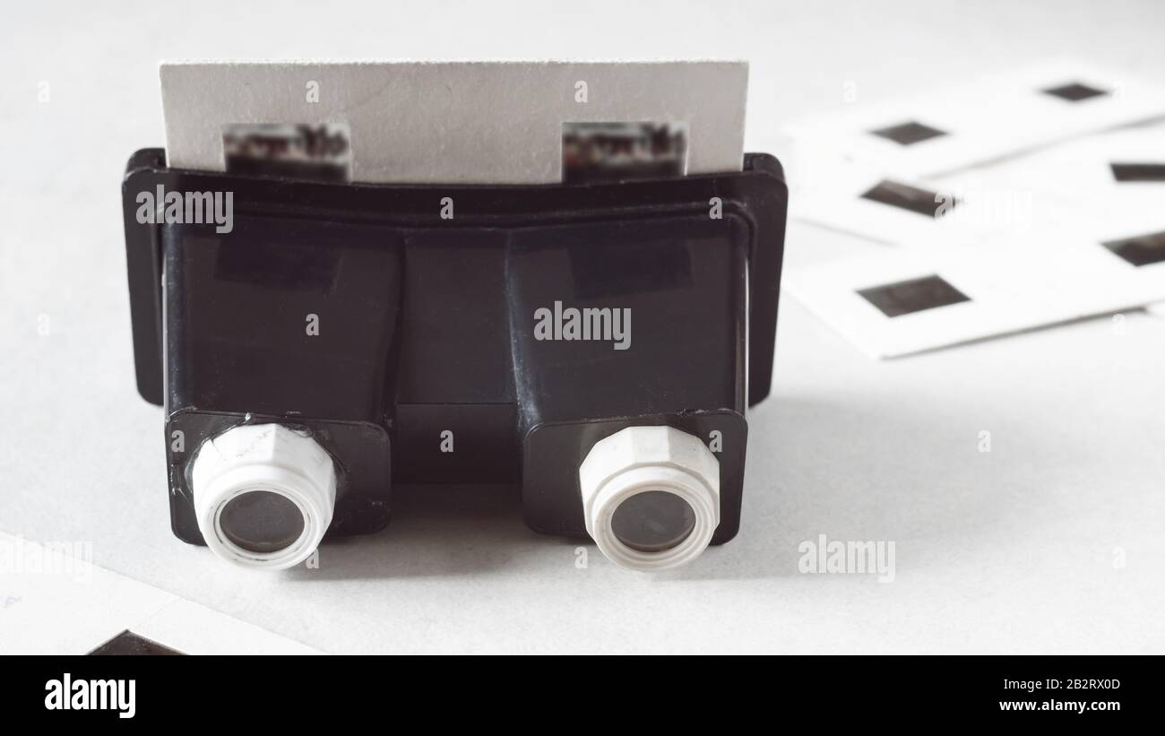 Old plastic stereoscope with a stereo card. Outdated 3D viewing device ...