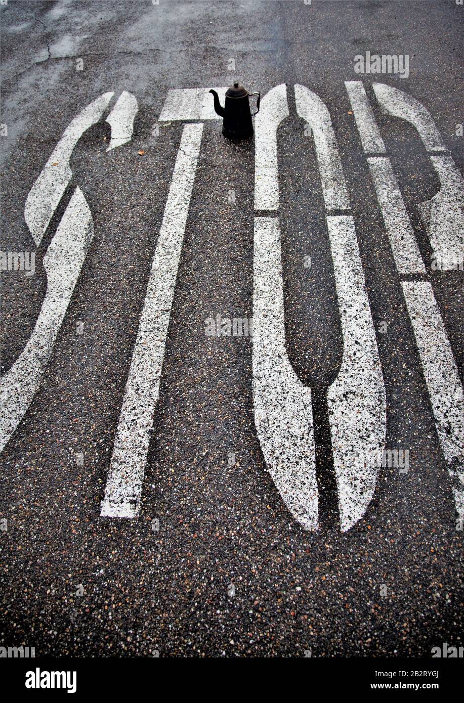 Stop sign painted on road with coffee pot which is outside drive thru ...