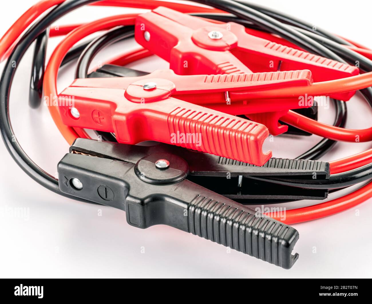 Black and red twisted jumper cables shot over white Stock Photo - Alamy