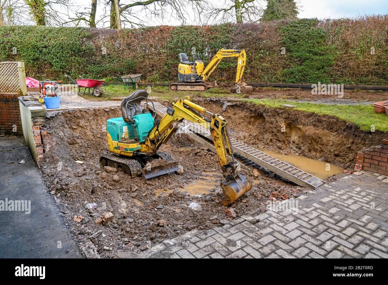 CARDIFF, WALES - FEBRUARY 2020: Mini excavators in the back garden of a ...