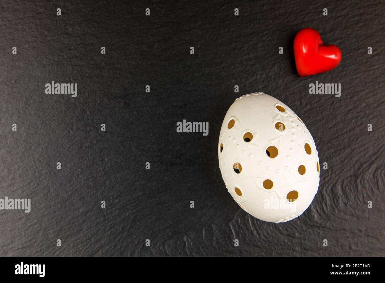 Easter egg on black slate. Symbol of Easter holidays. Christian feast ...