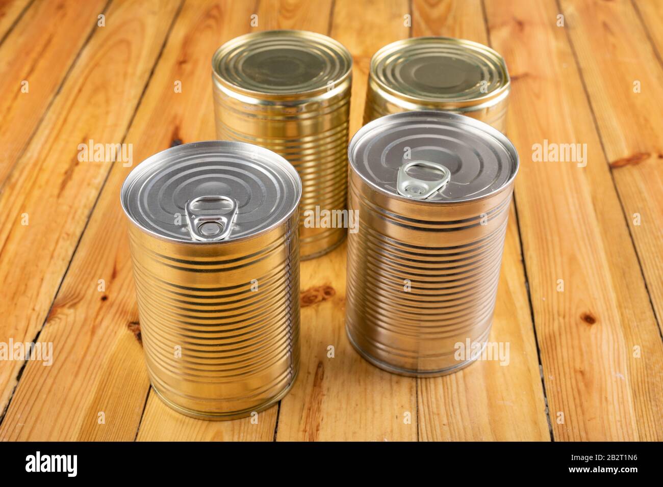 Can of cans on a kitchen wooden table. Preserved food in the household ...