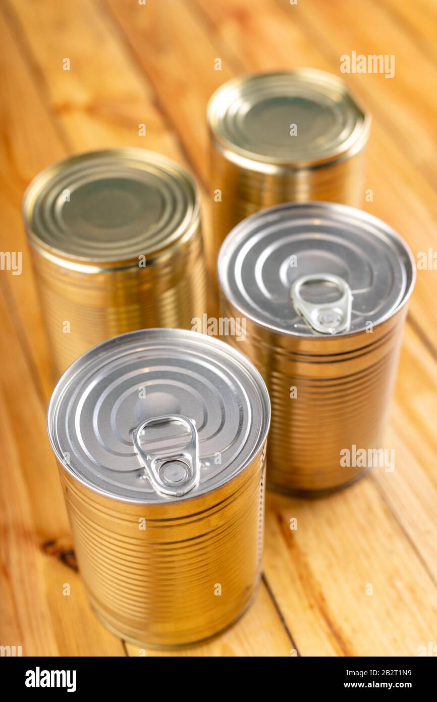 Can of cans on a kitchen wooden table. Preserved food in the household ...