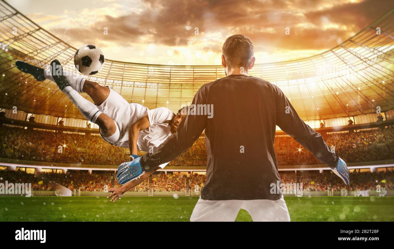 Soccer striker hits the ball with an acrobatic kick in the air at the ...