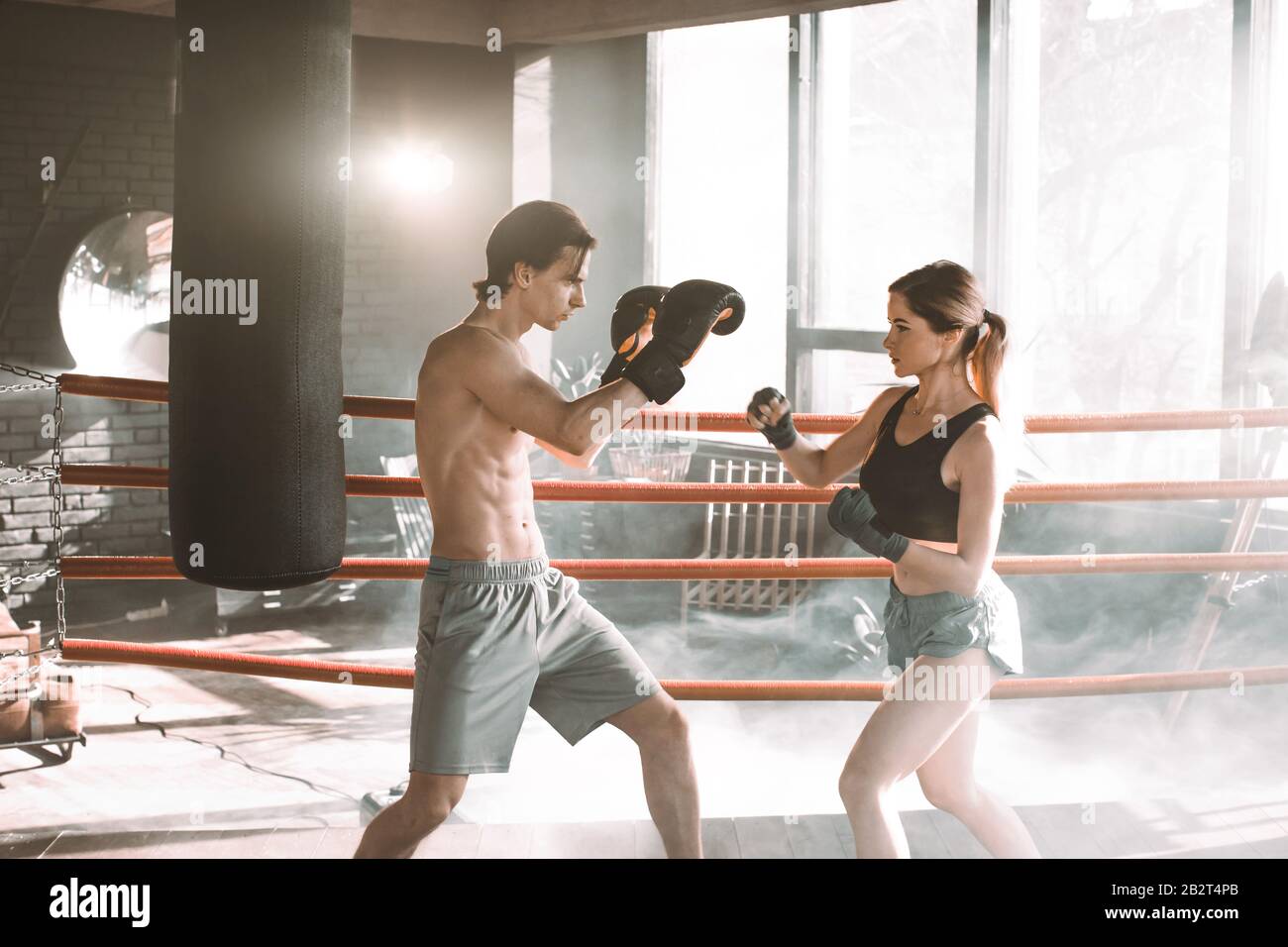 Boxing workout. Couple man and woman boxing together in the boxing ring ...