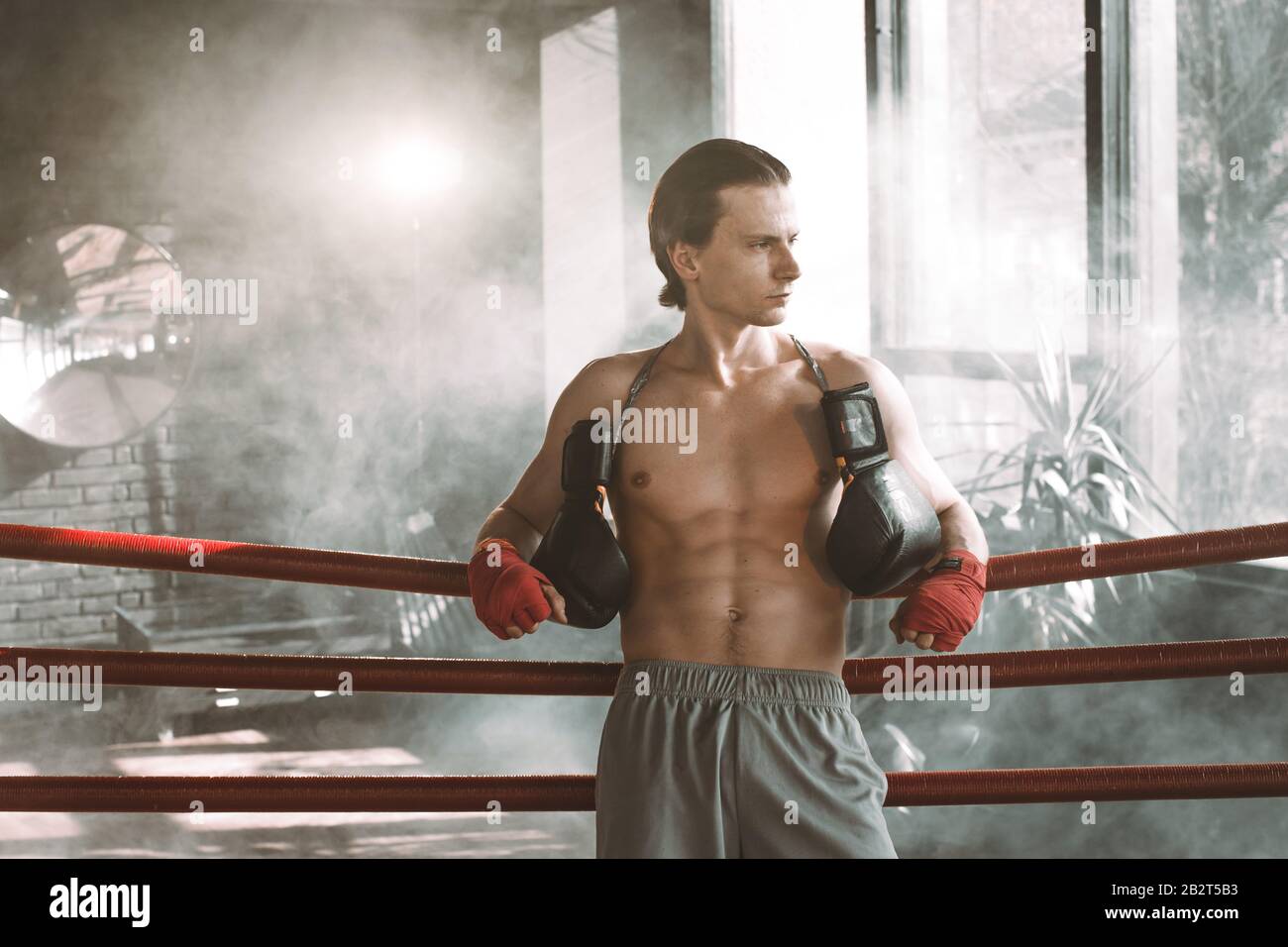 Male boxer having muscular body standing inside a boxing ring. Boxer ...