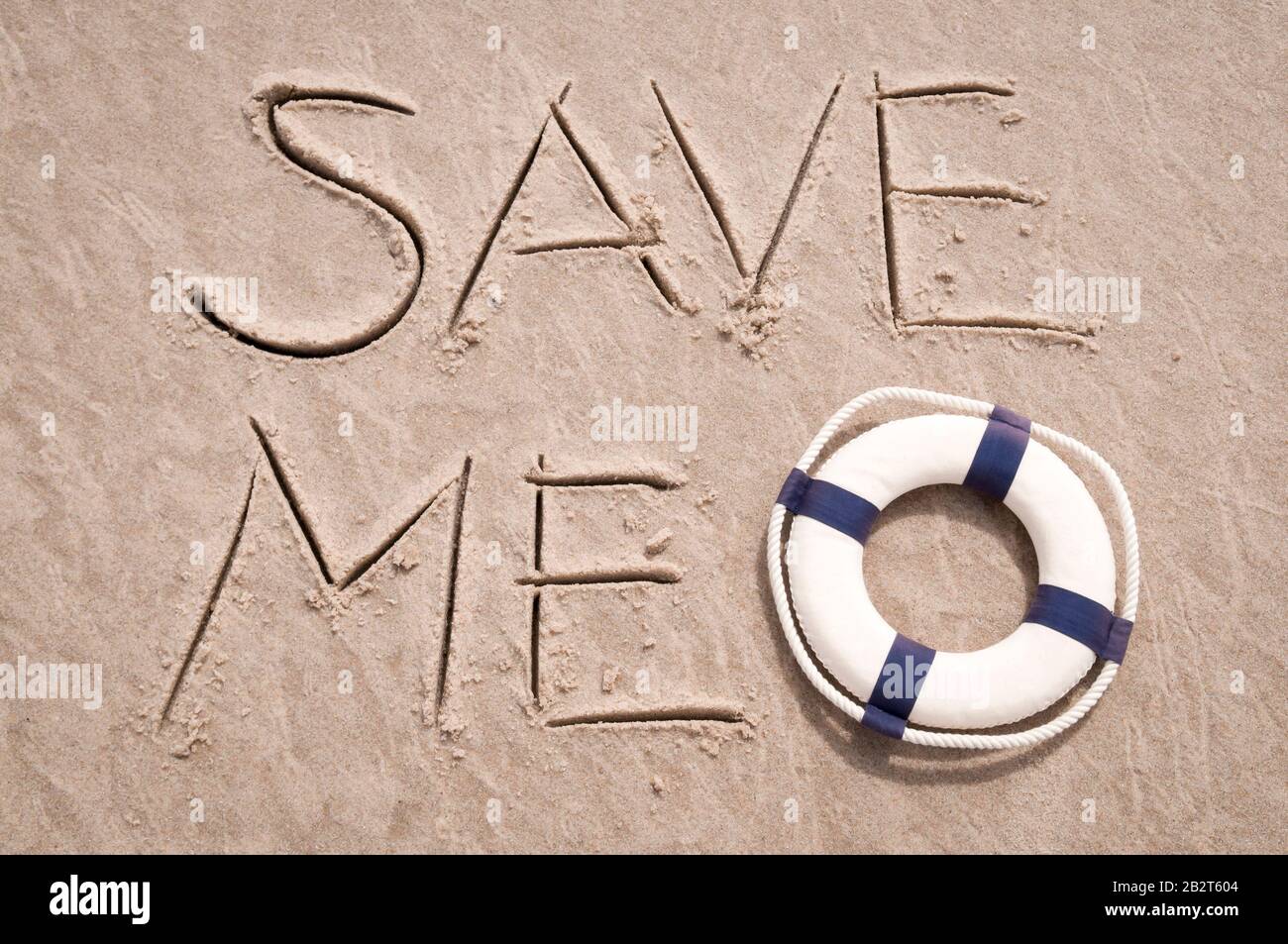 Save Me! message handwritten on the beach with lifesaver in smooth sand ...