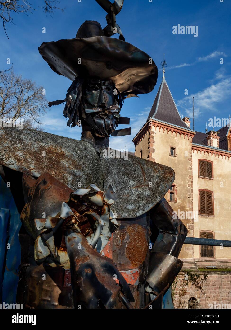 Iron statues of french musketeers on the background of an old castle ...