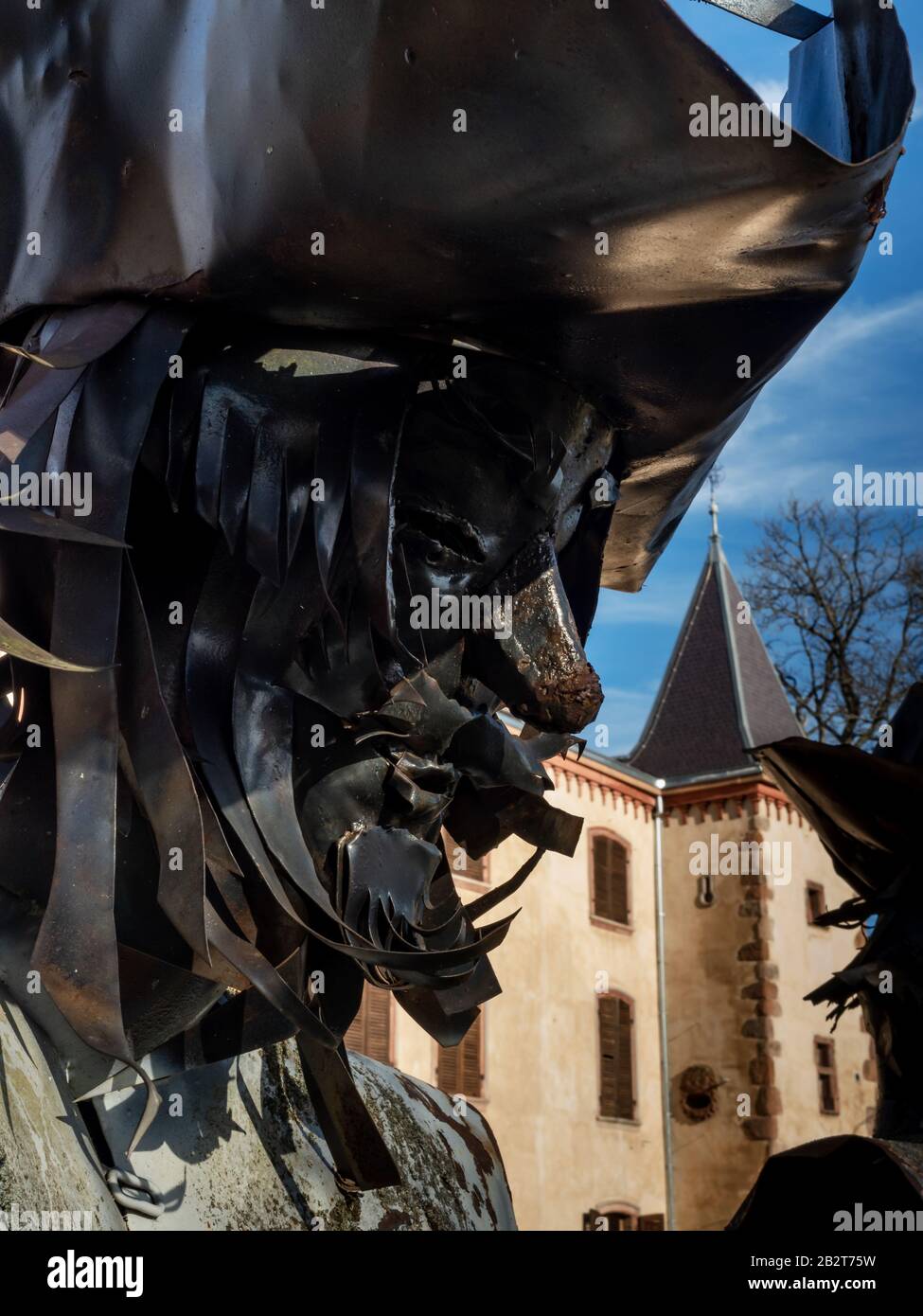 Iron statues of french musketeers on the background of an old castle ...