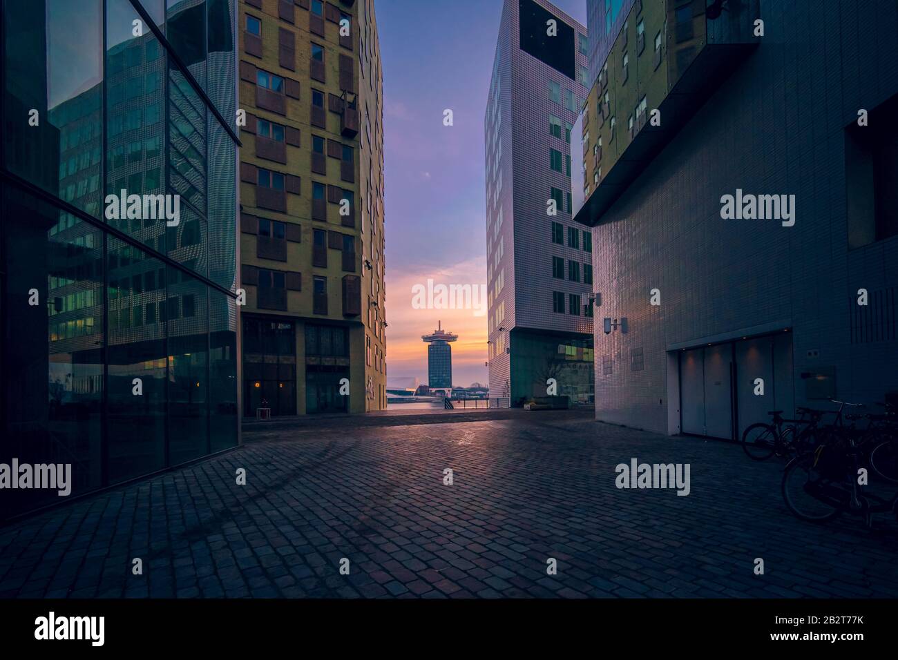 Modern buildings with glass windows under a cloudy sky during the ...