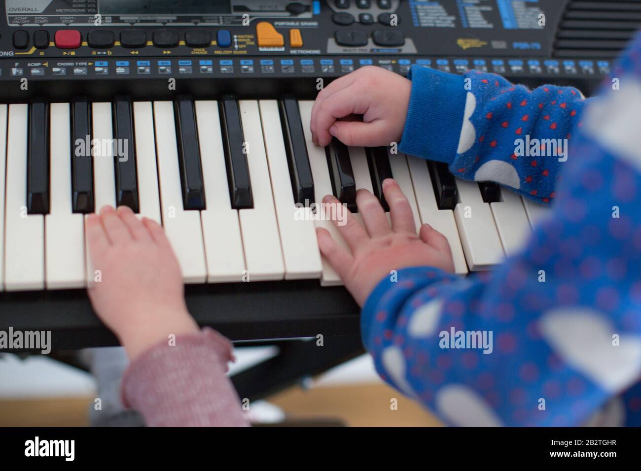 Children playing the keyboard Stock Photo - Alamy