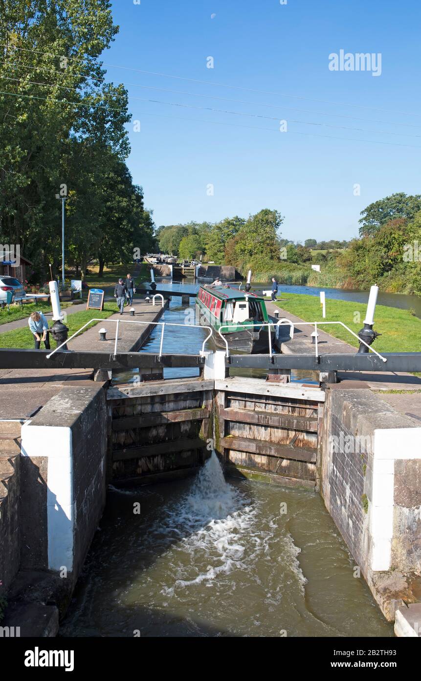 Woman opening a lock for a narrowboat or canal boat on the Grand Union ...