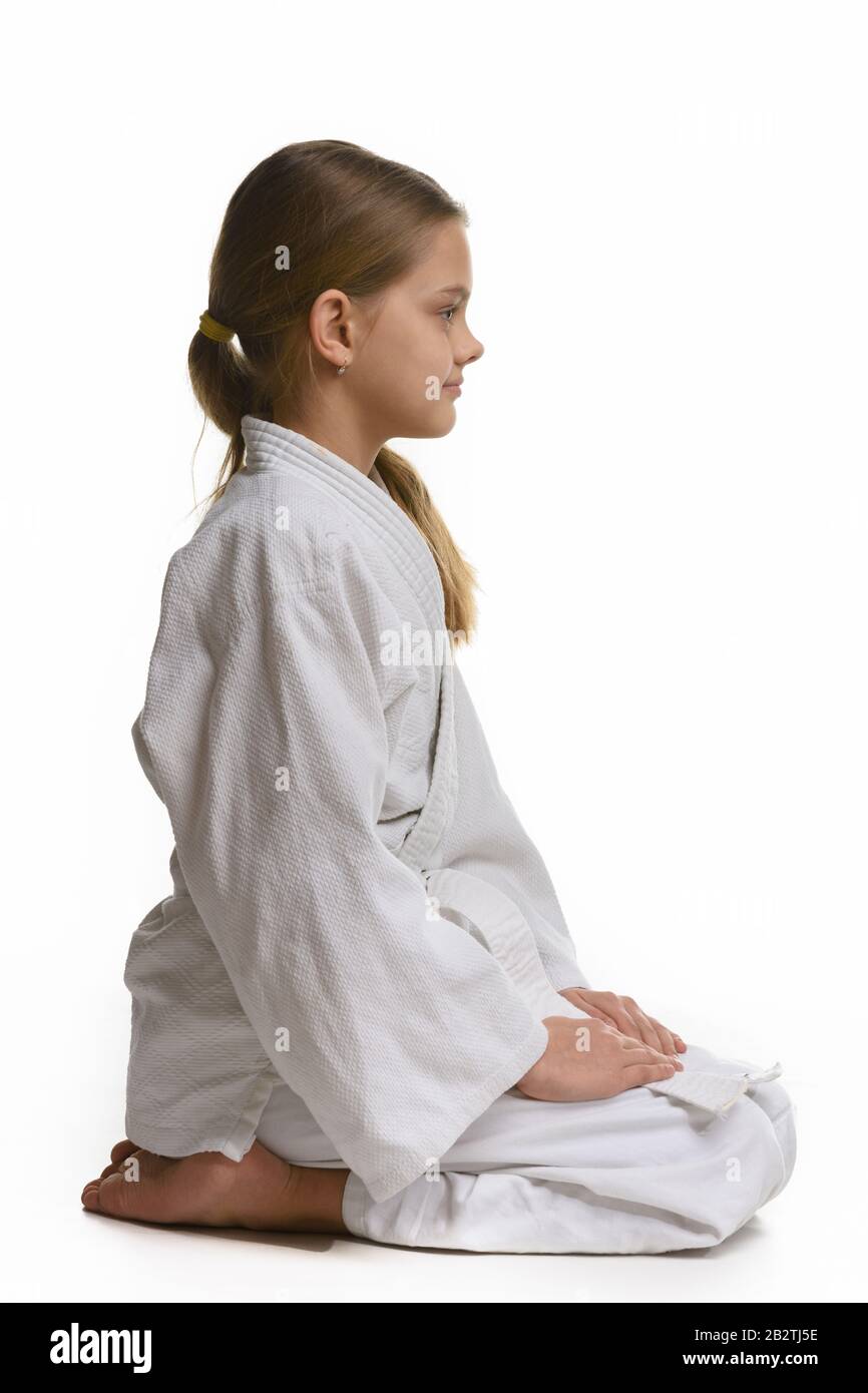 Judo student sits on the floor, view from the side Stock Photo - Alamy
