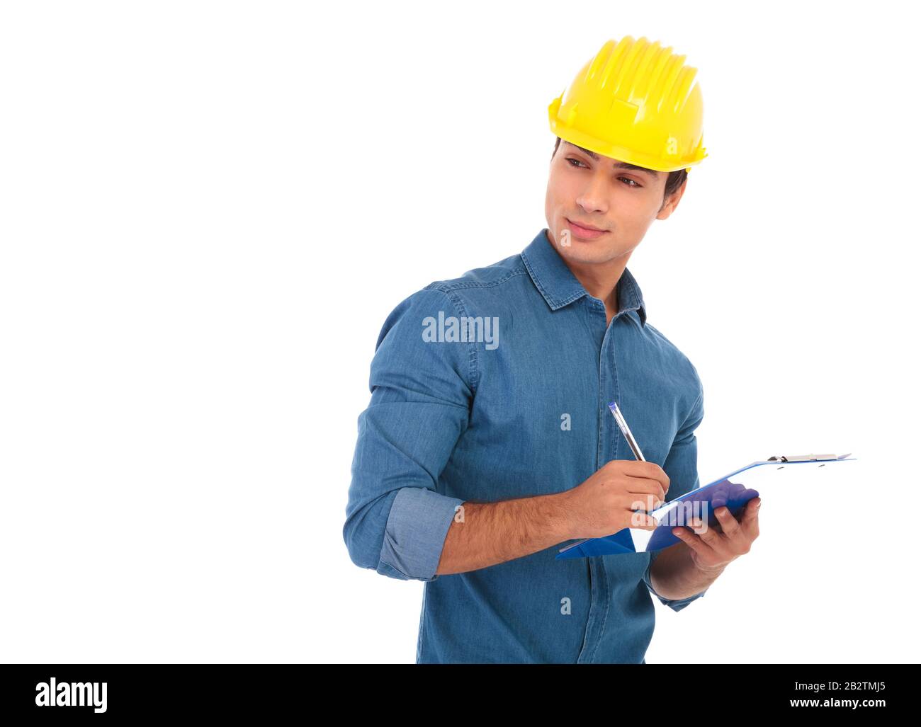 side view of a young construction engineering student writing on ...