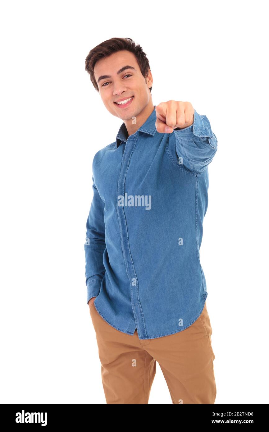 smiling casual man pointing finger to the camera on white background ...