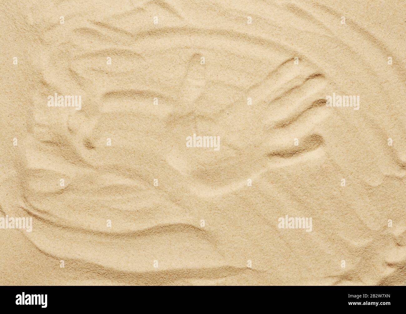 Tropical sand background. Sandy beach texture with handprint. Top view ...