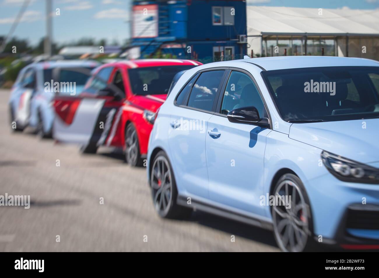 View of autodrome race circuit racetrack with a line of cars driving ...