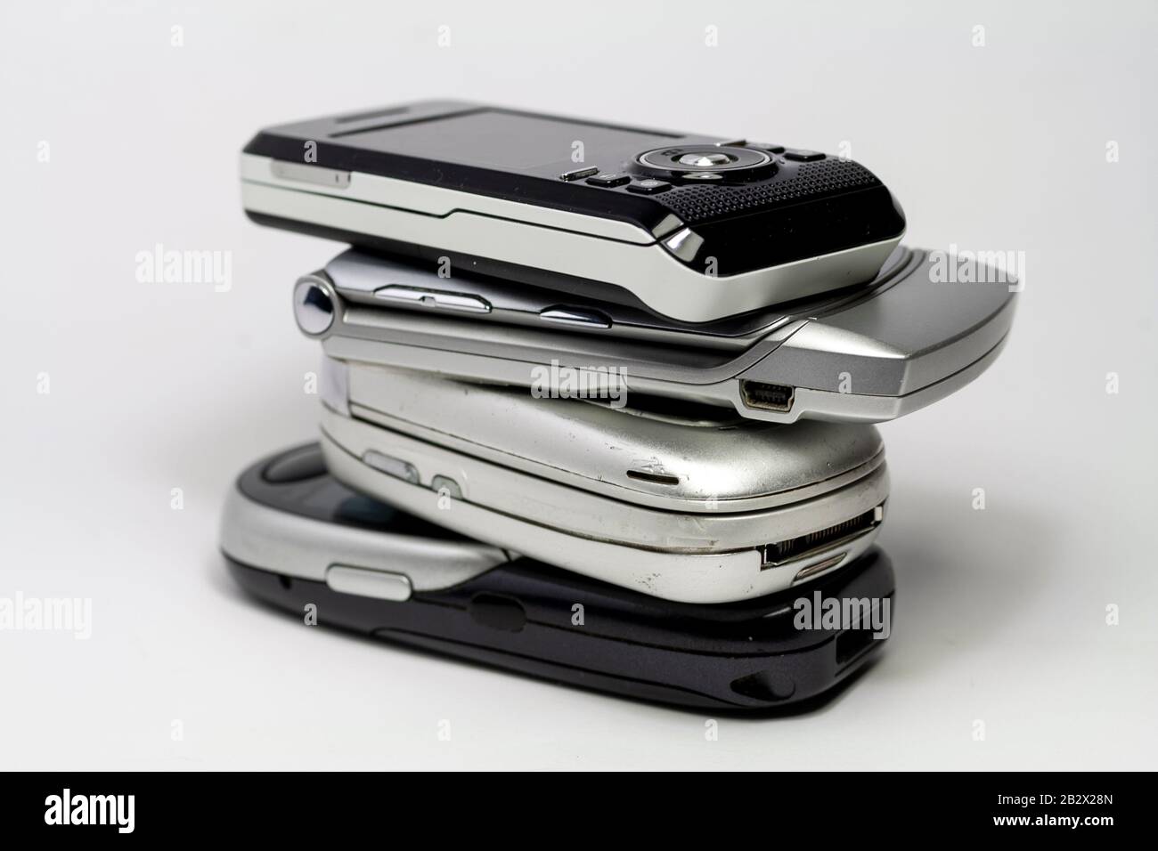 Stacked old mobile phones on white background Stock Photo - Alamy