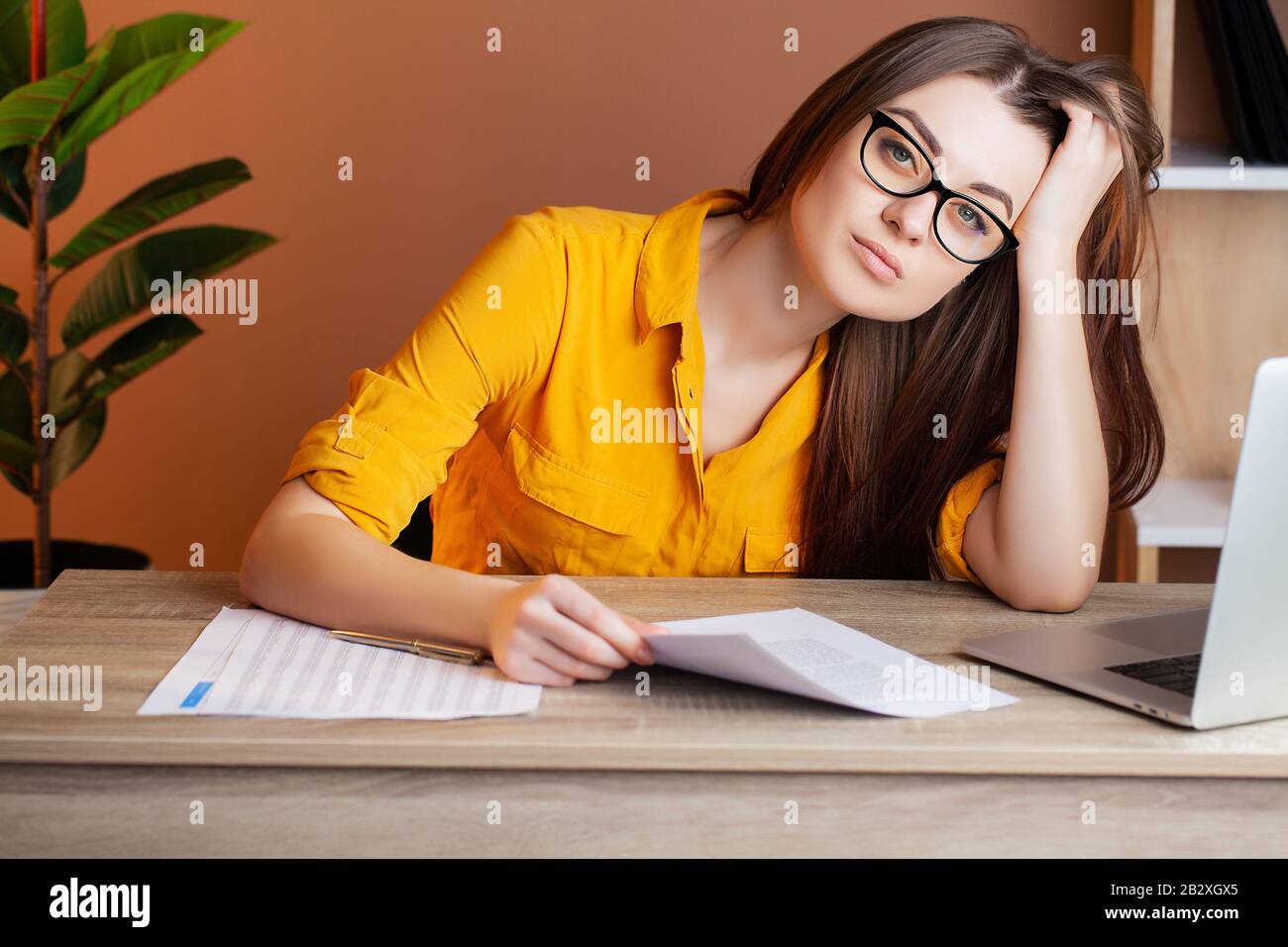 Tired woman working at the computer in the office Stock Photo - Alamy