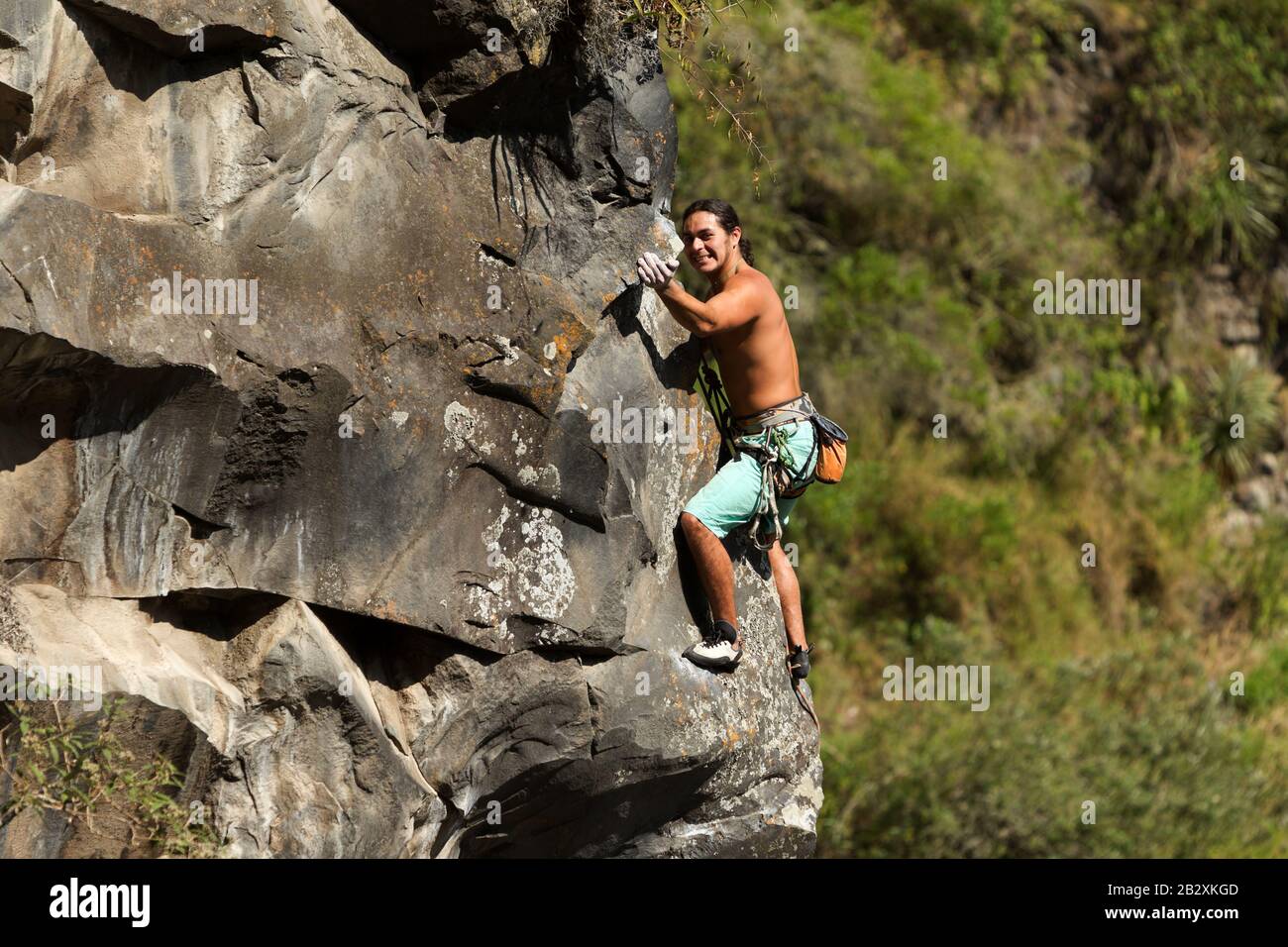Rock Climber Climbing Up A Cliff Stock Photo - Alamy
