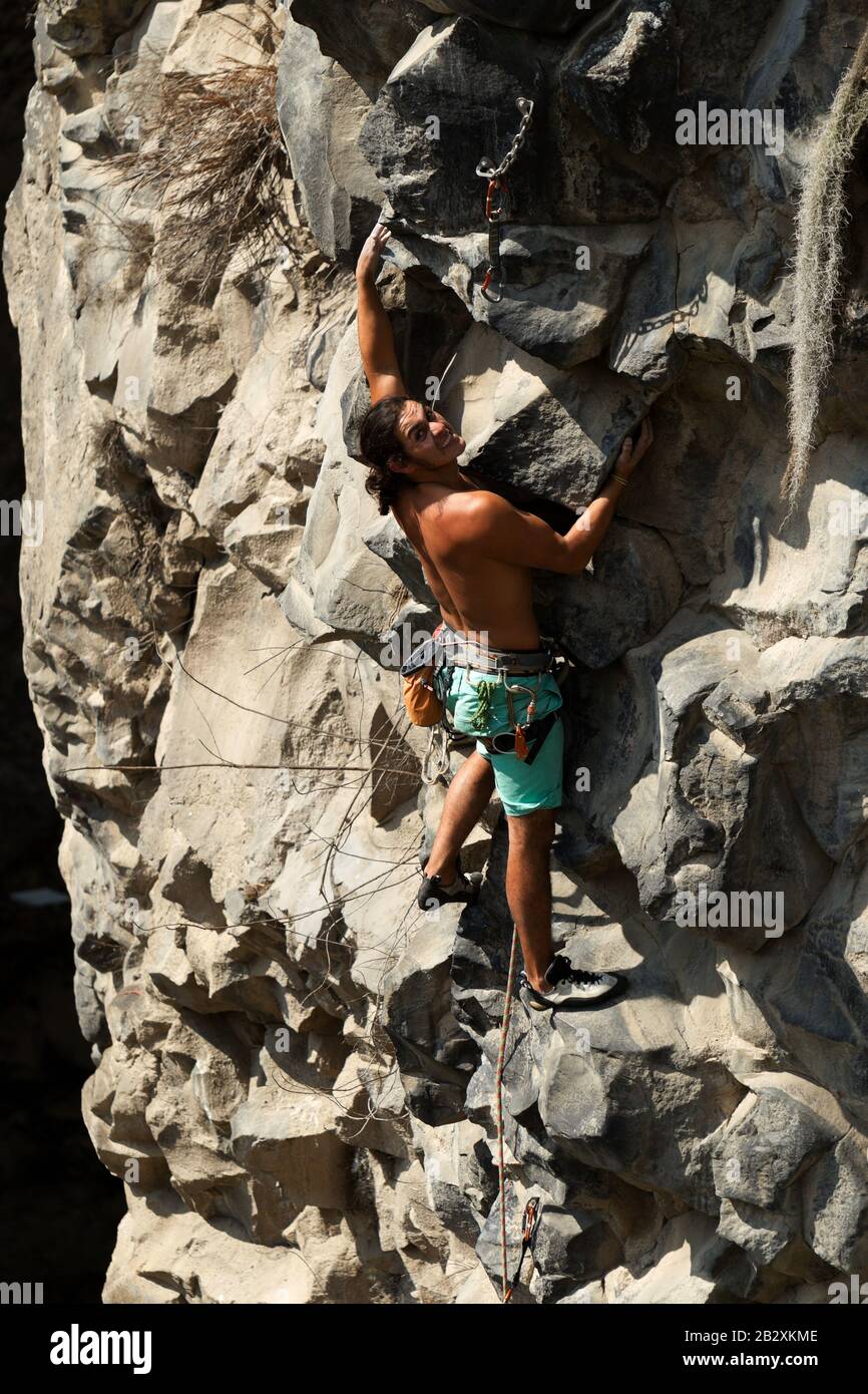 Rock Climbers Climbing Up A Cliff Stock Photo - Alamy
