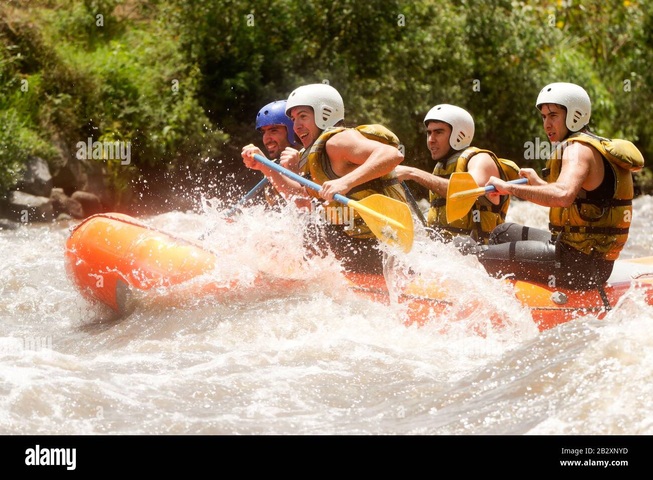 Young men whitewater rafting hi-res stock photography and images - Alamy