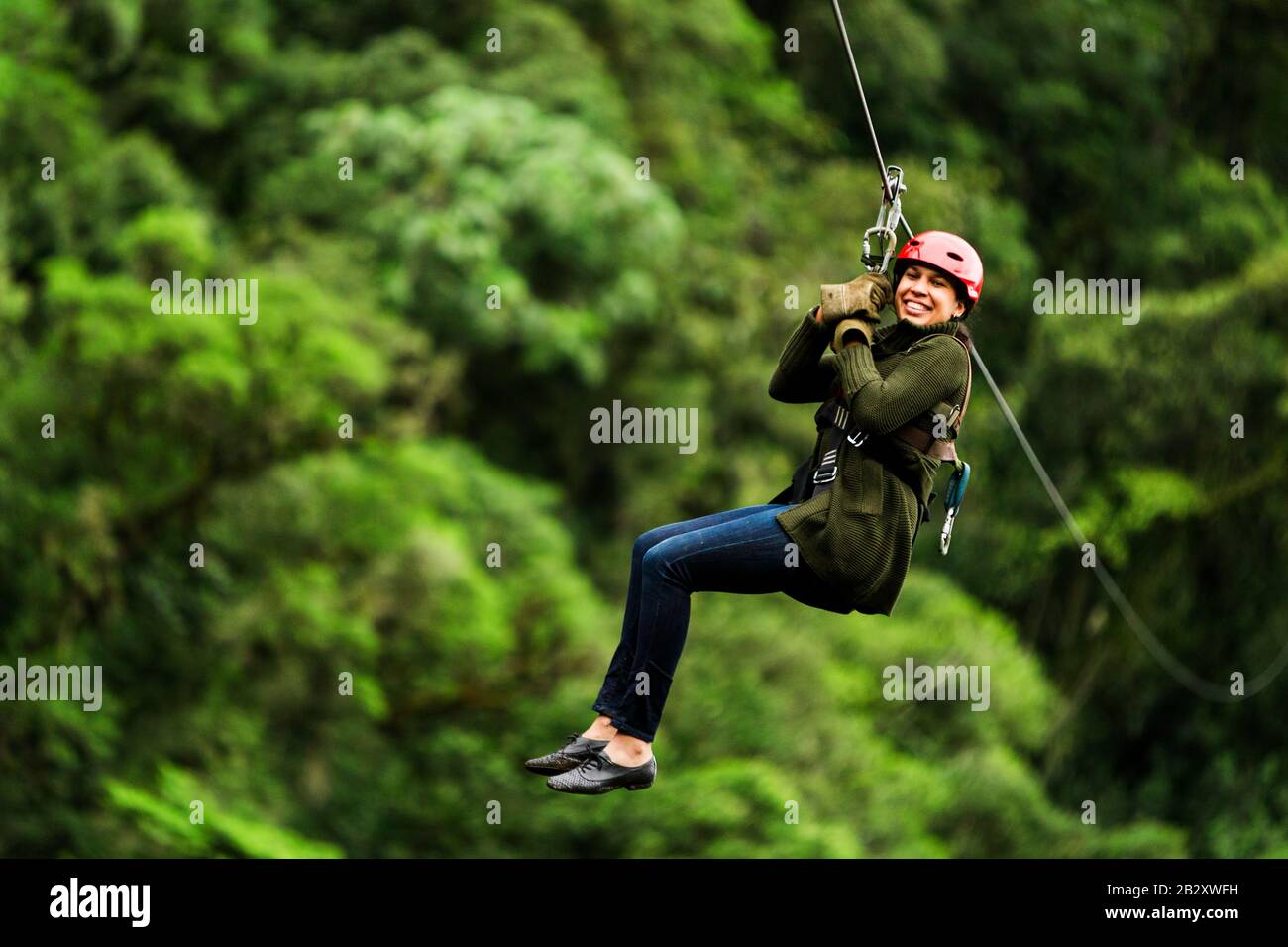 Adult Lean Afro Lady On Zip Line In Ecuadorian Rainforest Nearby Banos ...