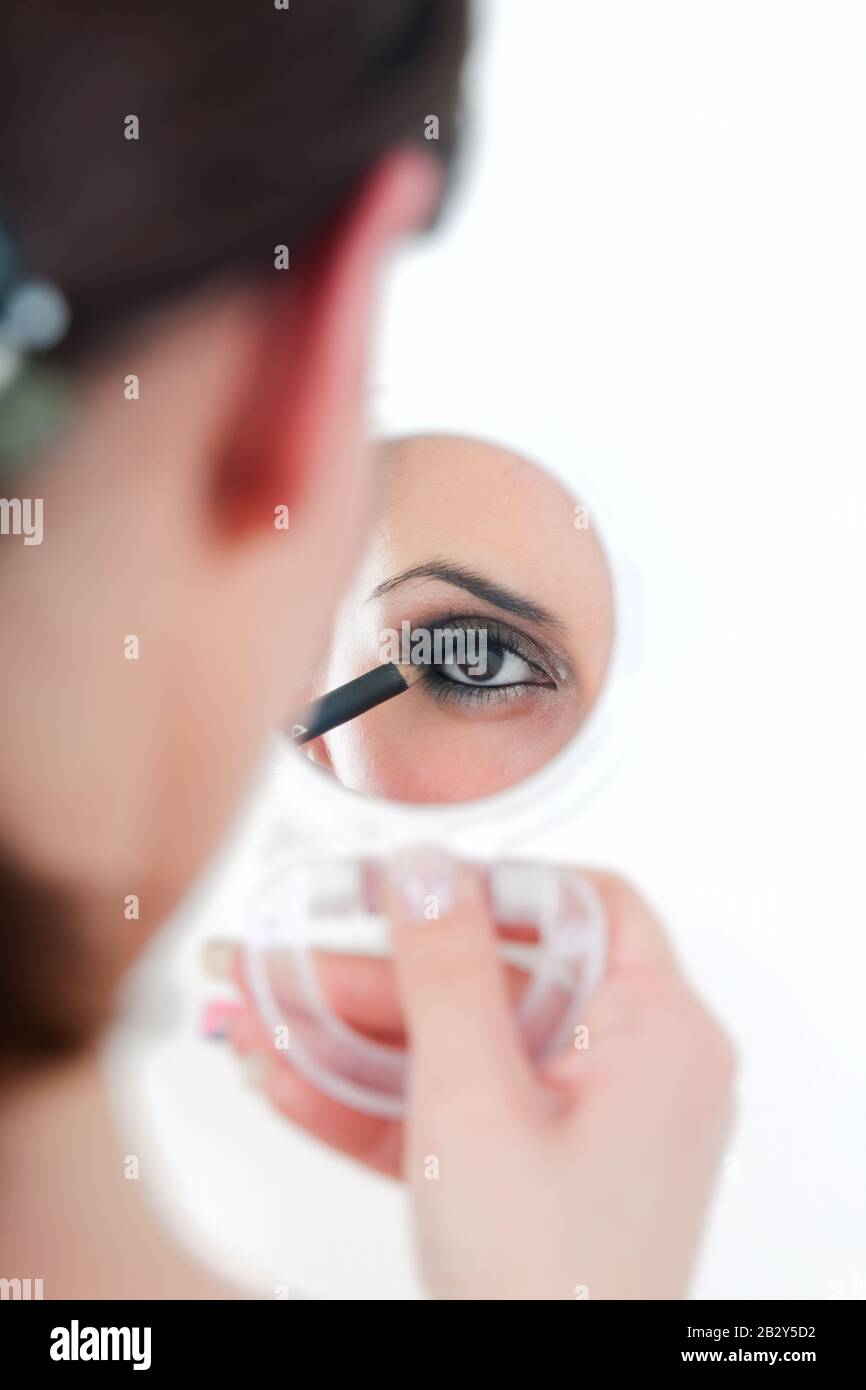 Woman Creating An Eye Makeup View In A Mirror Stock Photo - Alamy