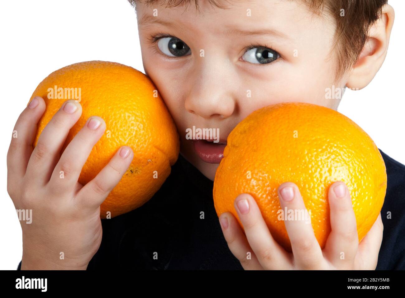 Young Children Holding Big Oranges In Both His Hands Stock Photo - Alamy