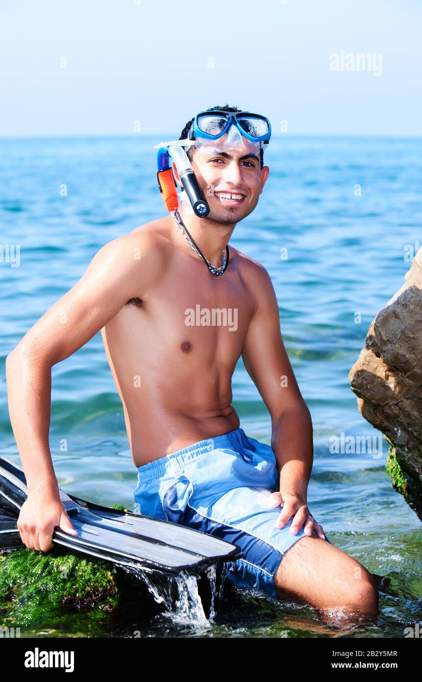 Snorkeler Resting On Land With His Diving Equipment Stock Photo - Alamy