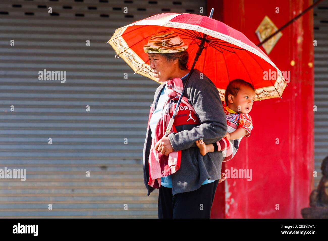 Mae Sai, Thailand - November 29th 2011: Ethnic burmese woman and child crossing the border. This ...