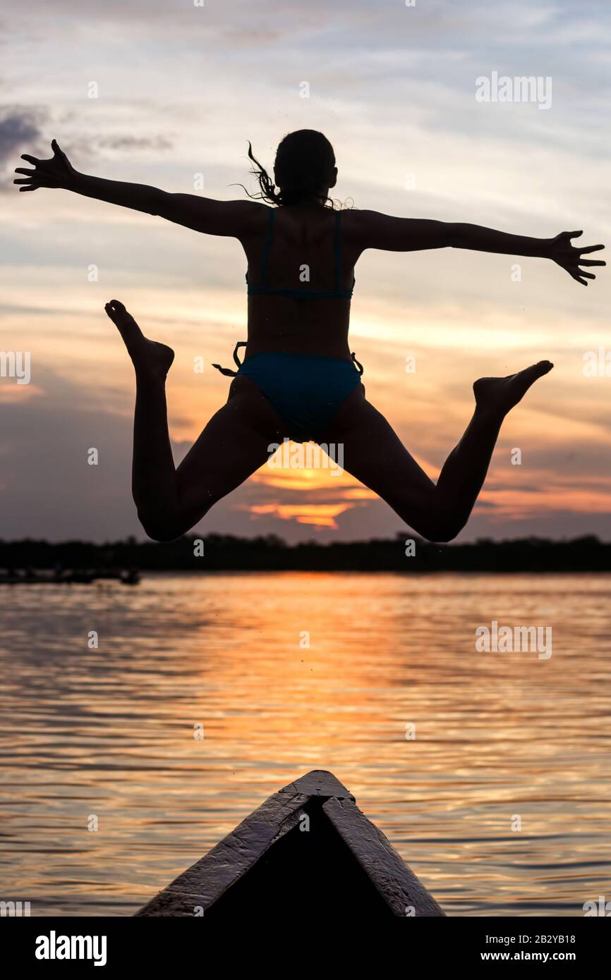 Woman jumps lake hi-res stock photography and images - Alamy