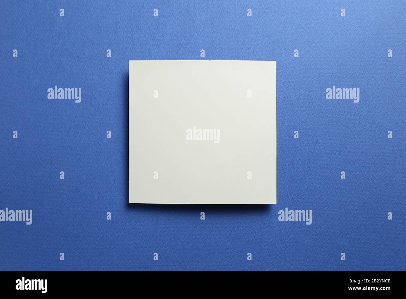 White memo pad, empty paper on dark blue background. top view, copy ...