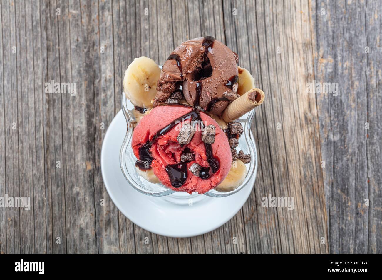 Vanilla, strawberry and chocolate sundae dish ice cream with wafer ...