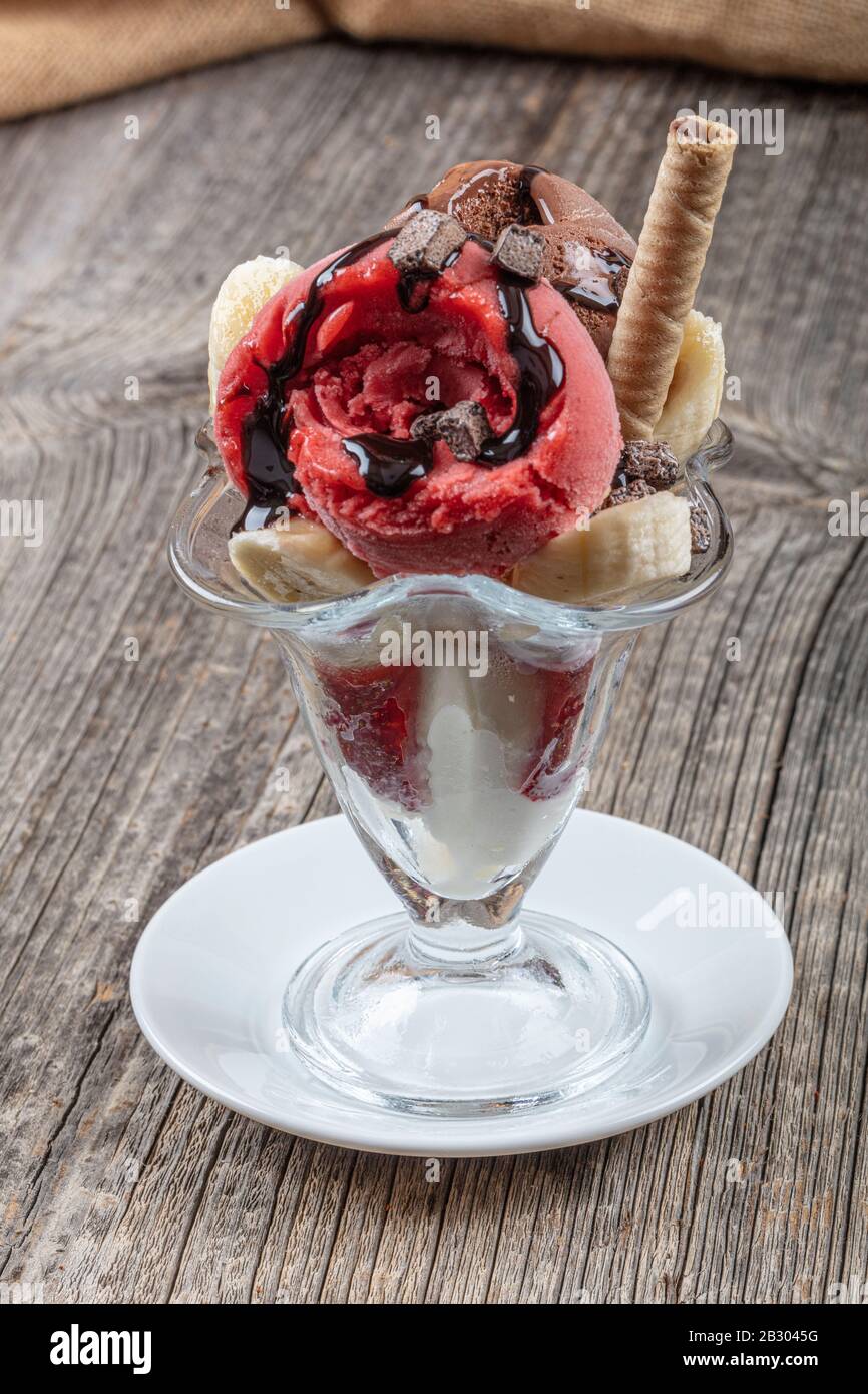 Vanilla, strawberry and chocolate sundae dish ice cream with wafer ...