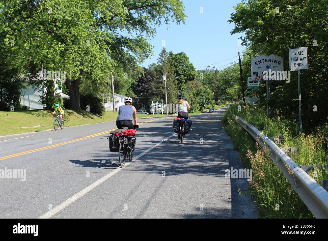 Three women riding bicyles entering Williamstown, Massachusetts at the ...