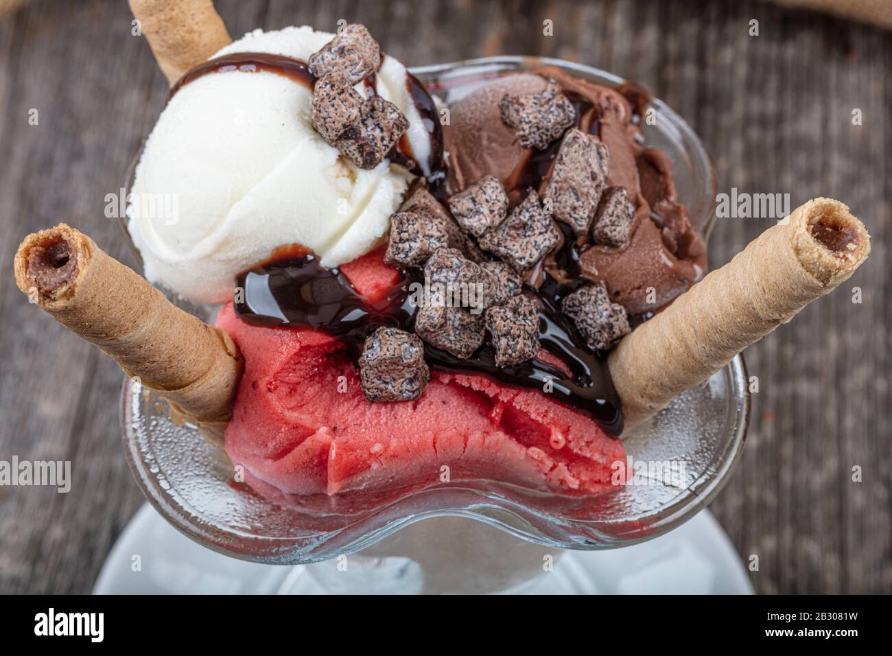 Vanilla, strawberry and chocolate sundae dish ice cream with wafer ...