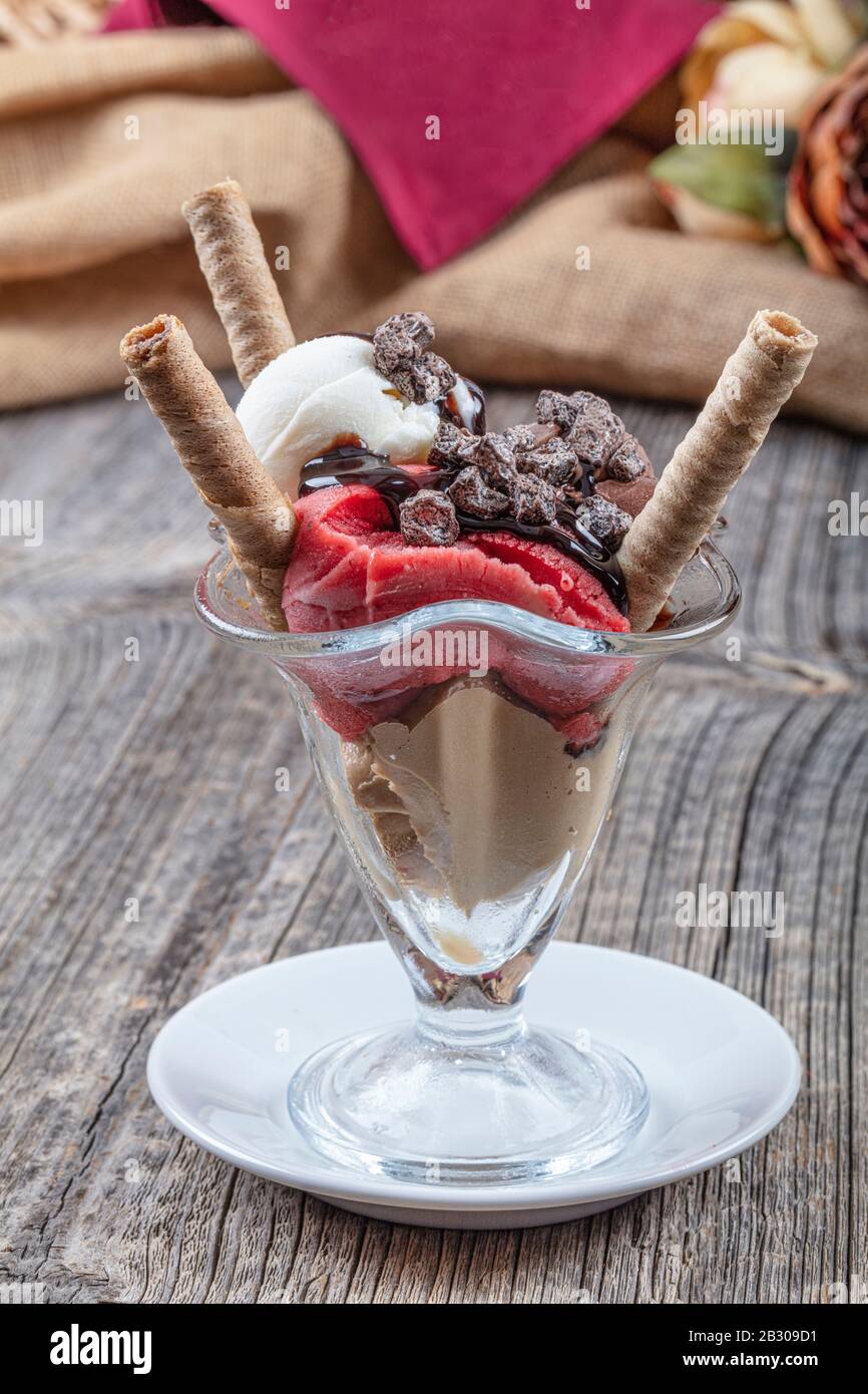 Vanilla, strawberry and chocolate sundae dish ice cream with wafer ...