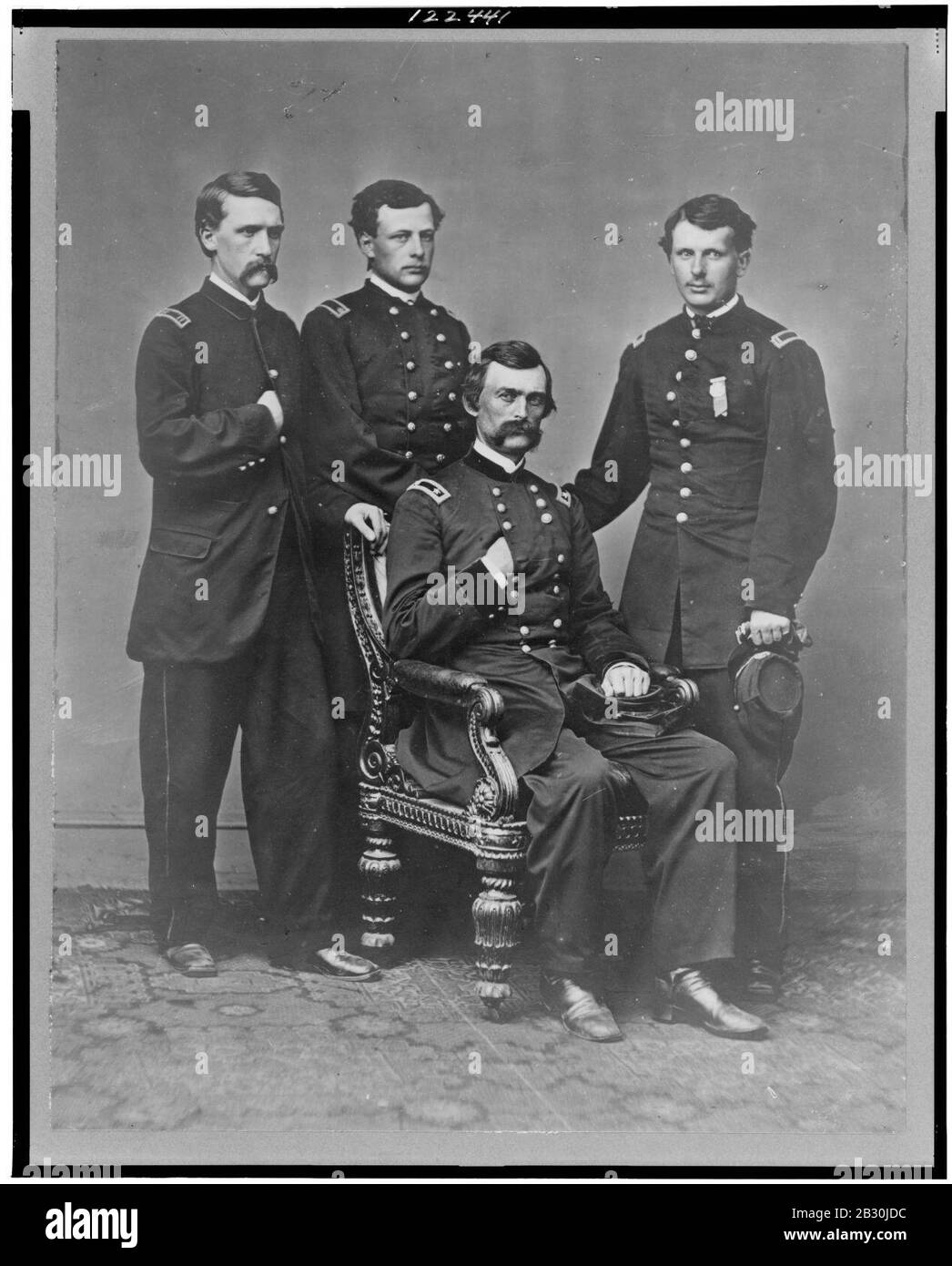 General Charles Griffin, full-length portrait, seated, with three aides ...