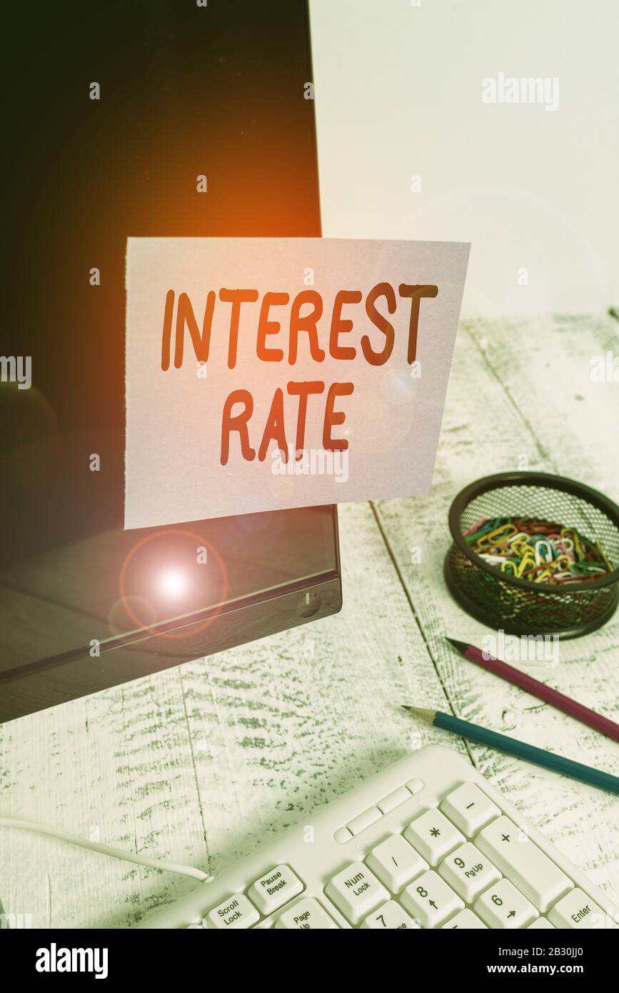 Handwriting text Interest Rate. Conceptual photo percentage of ...