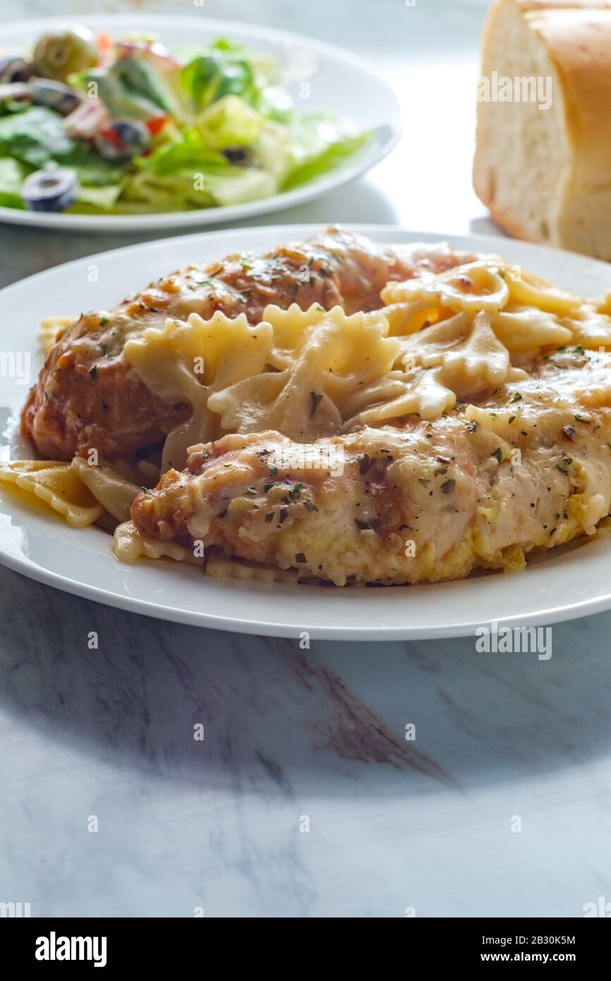 Italian American Chicken francese with farfalle pasta side salad and ...