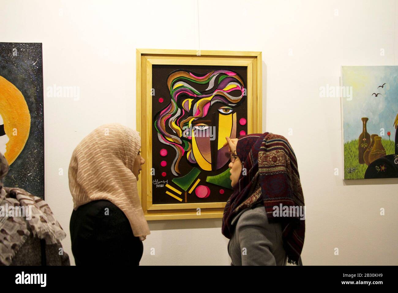 Gaza. 3rd Mar, 2020. Visitors look at exhibits during an exhibition ...