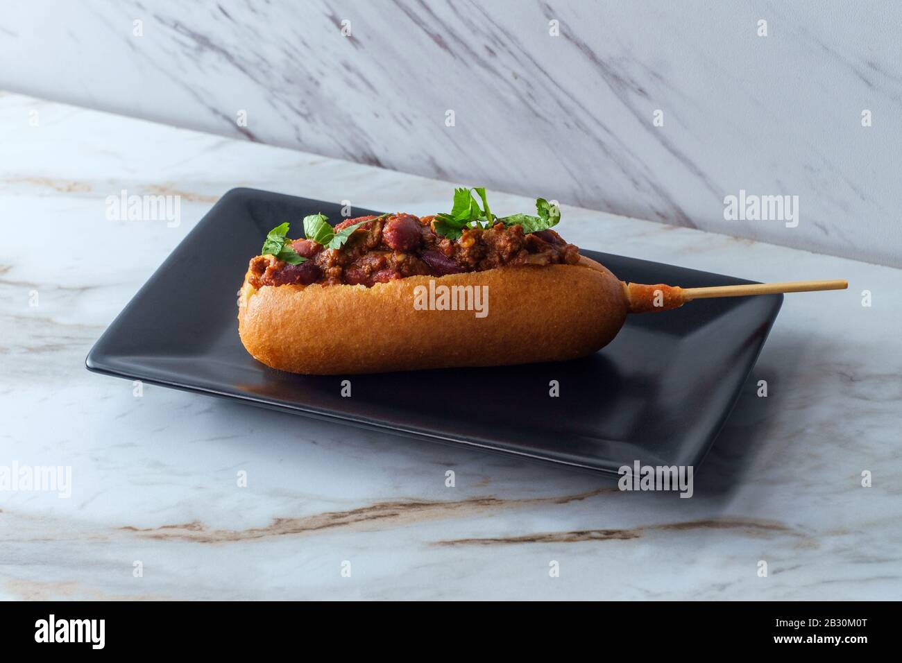 American fast-food chili corn dog on marble kitchen table Stock Photo ...