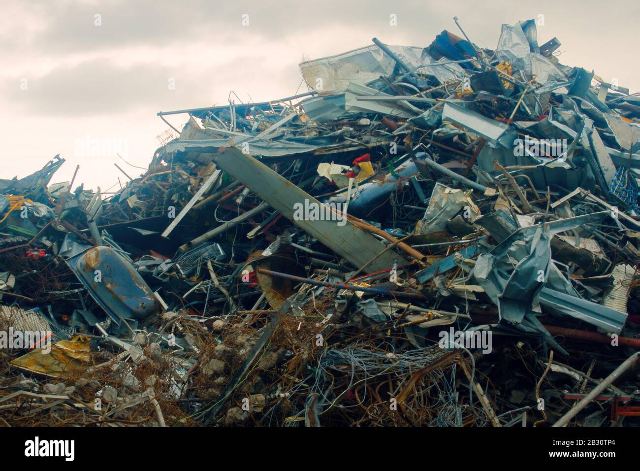 Piles of scrap metal for recycling in an open-air warehouse. Collection ...