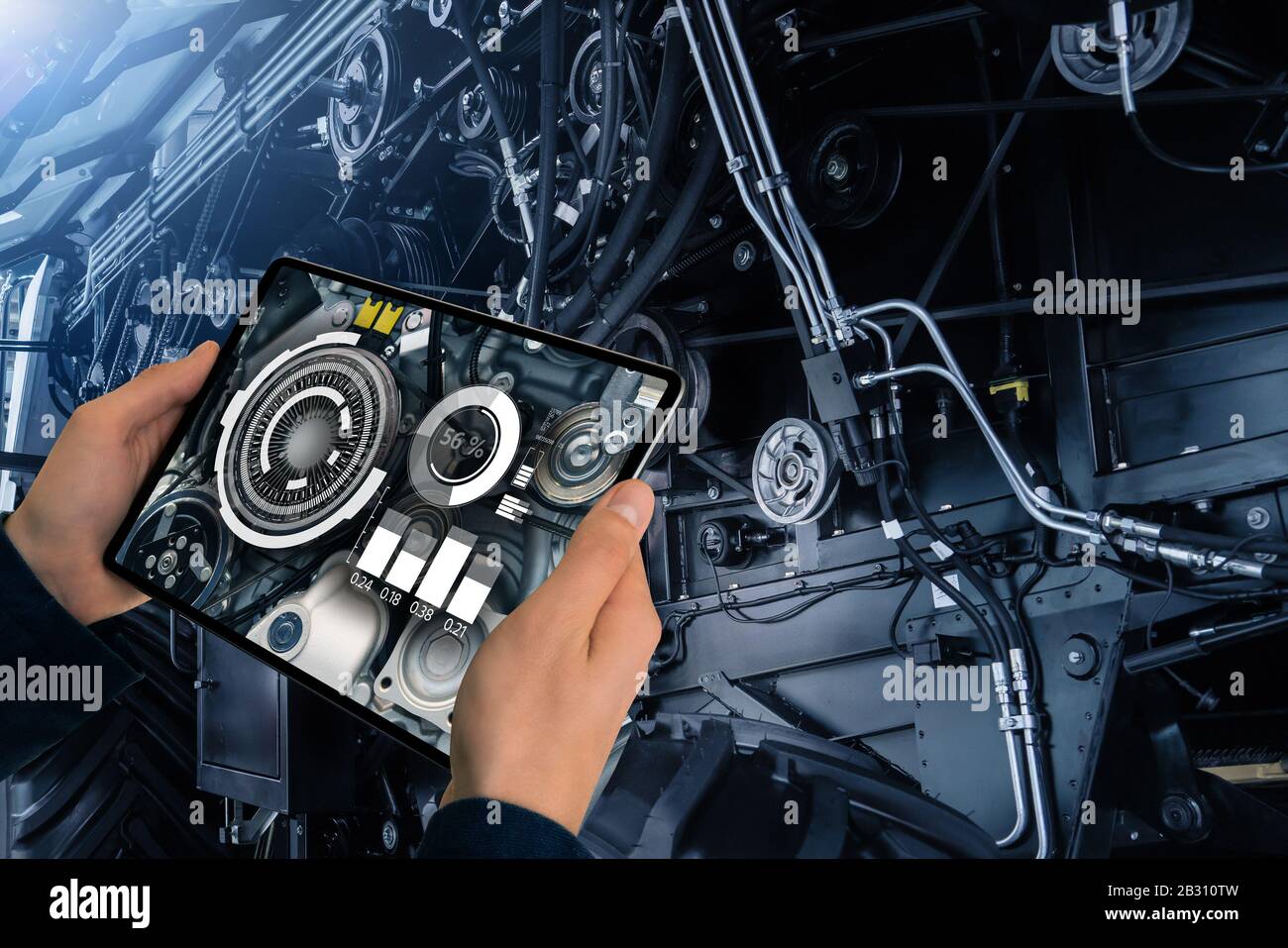 Serviceman repairing a tractor using augmented reality application ...